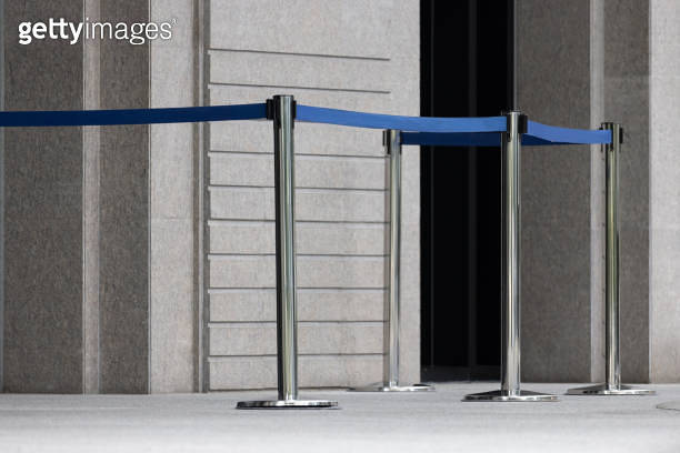 stainless steel bollard with blue line barricade in front of the ...