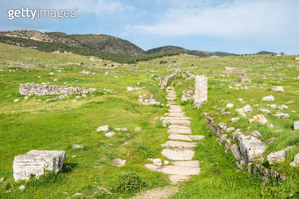 Stone path through the ruins of Hierapolis ancient site in Pamukkale ...