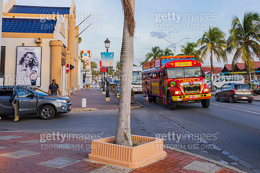 View of tourist bus on road in center of Oranjestad on island of Aruba ...