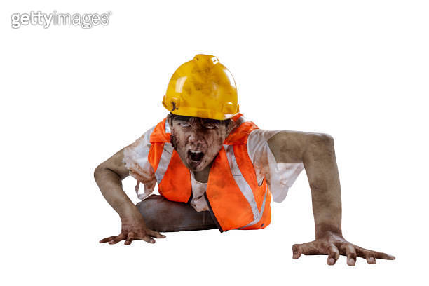 A scary construction worker zombie with blood and wounds on his body ...