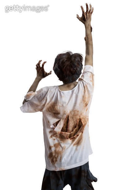 Rear view of a scary zombie with blood and wounds on his body walking ...