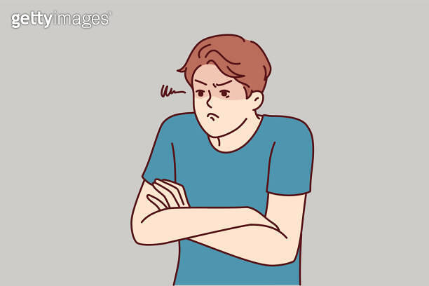 Angry man with hands folded in front of chest demonstrates envy and ...