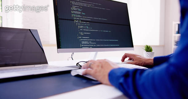 Computer Programmer Writing Program Code On Computer (1493901979) - 게티이미지뱅크