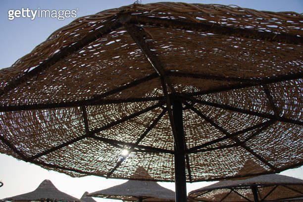wicker umbrella on a hotel beach in egypt on a sunny day (1496836717 ...