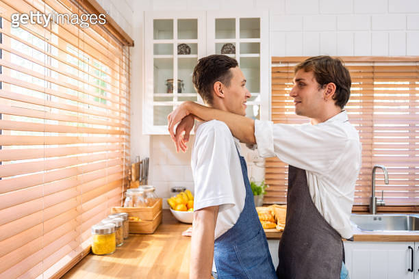 Caucasian young lgbtq gay family eating breakfast in the morning ...