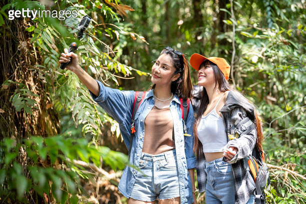 Asian two young beautiful women backpacker traveling in forest wild ...