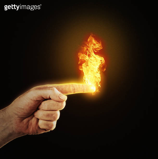 Fire bursts from a man's pointing fingertip 이미지 (1464421086) - 게티이미지뱅크