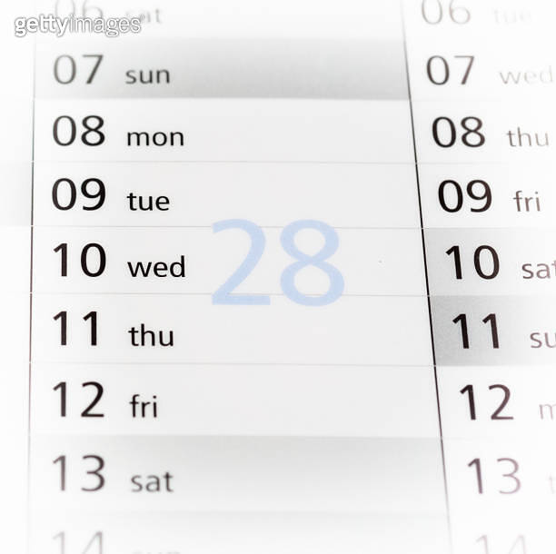 Close-up of a year planner calendar, with dates, days and week number ...