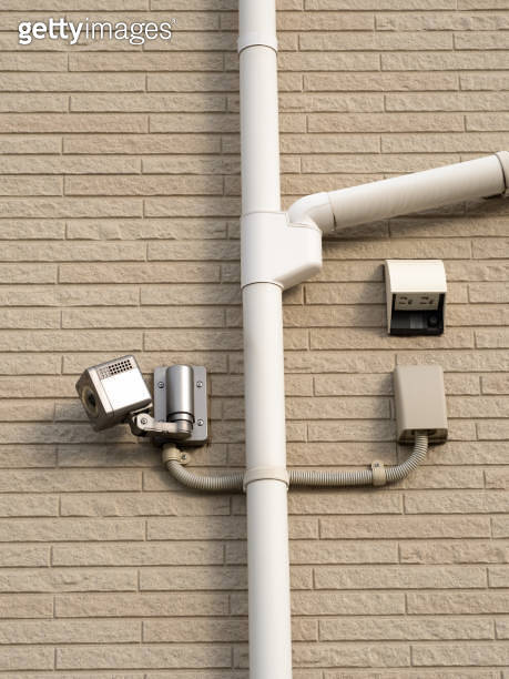 A residential rain gutter equipped with a security camera A residential ...