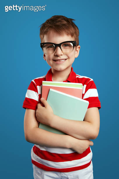 Vertical photo of little cute genius boy in nerdy glasses and red ...
