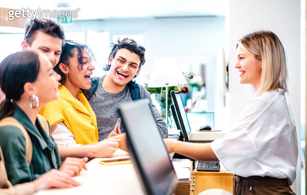 Young diverse friends having fun time at luxury hotel reception on ...