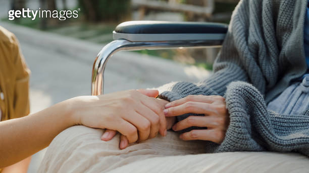 Closeup of young Asian people holding hands trust comfort help cancer ...