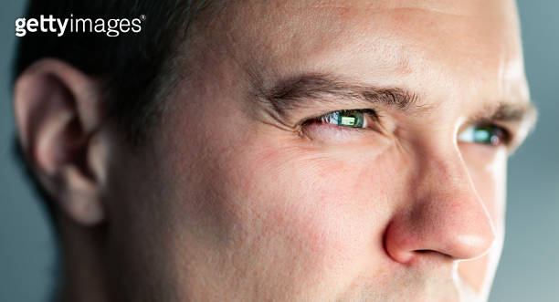 Squinting eyes of a man looking at screen. Poor eyesight, bad vision ...