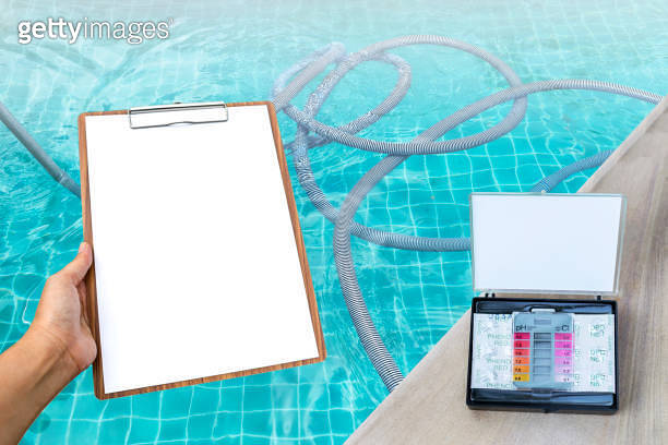 Water tester test kit with blank clipboard over vacuum hose floating in ...