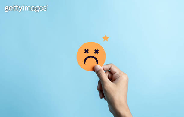 Hands holding sad face and happy smiley face on brain paper cut out ...