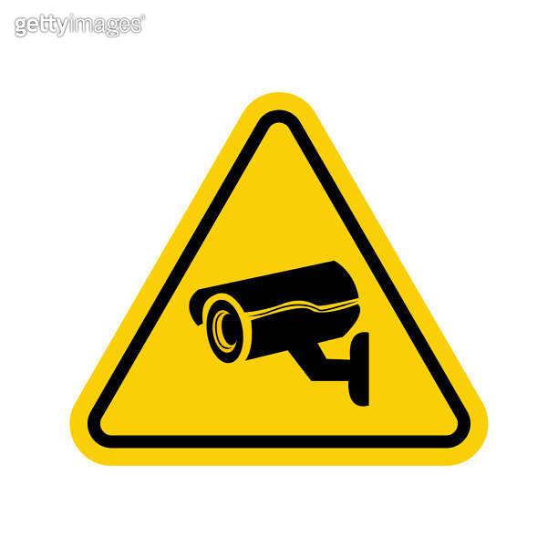 CCTV camera sign. Yellow triangle indicating camera operation. Camera ...