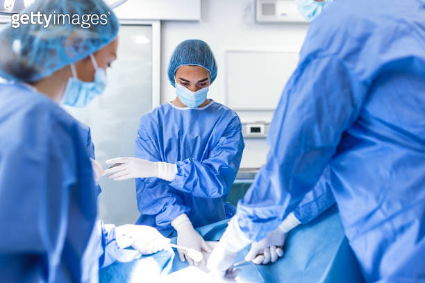 Surgery operation. Group of surgeons in operating room with surgery ...