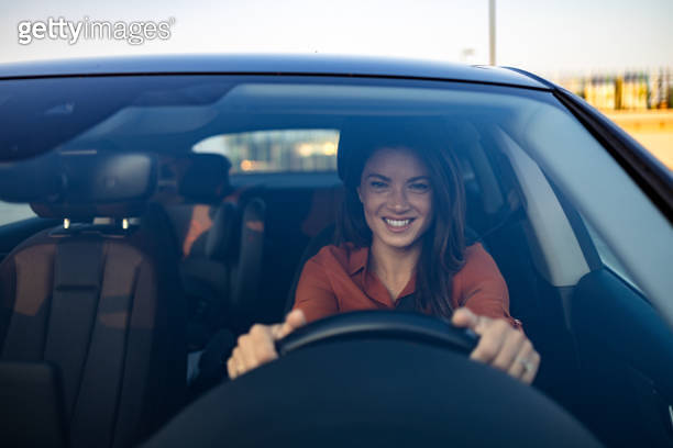 Happy woman driving a car and smiling. Cute young success happy ...