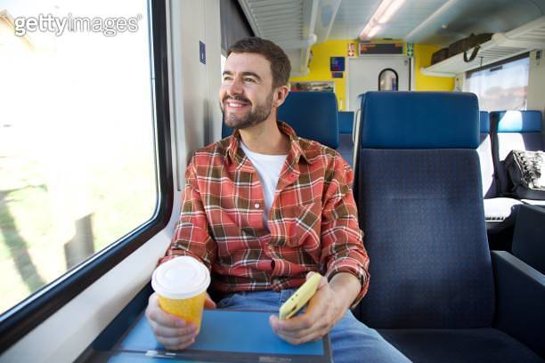 Handsome man sitting on train 이미지 (1700835277) - 게티이미지뱅크