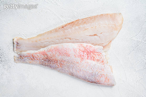 Raw red perch fillet, redfish fish meat. White background. Top view ...