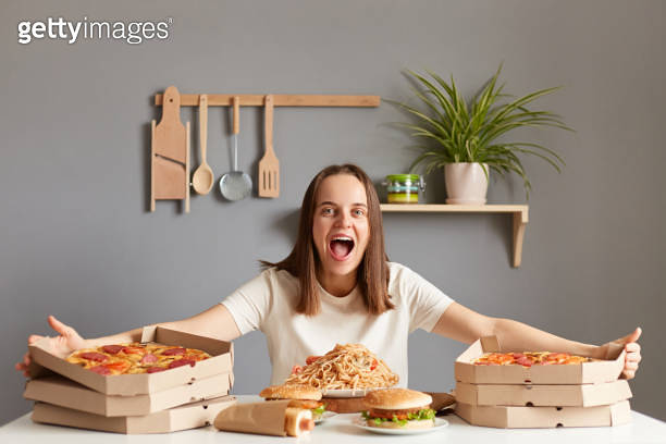 Extremely hungry crazy funny Caucasian woman wearing white casual T ...