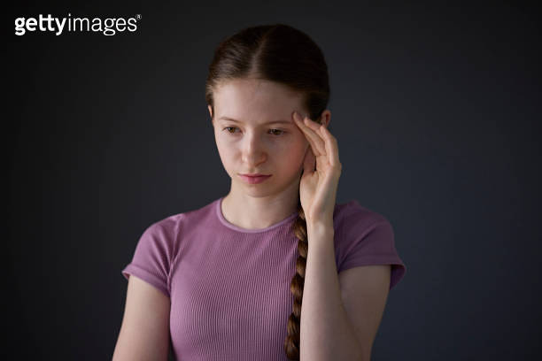 Low Key Studio Portrait Of Stressed Teenage Girl Worried About Mental ...