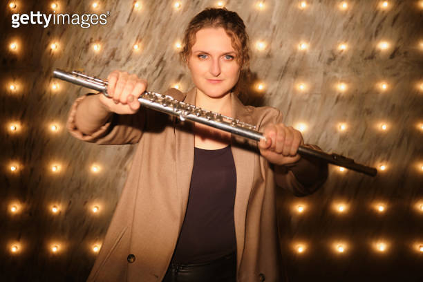 The female flautist, an accomplished musician, lit up the stage with ...