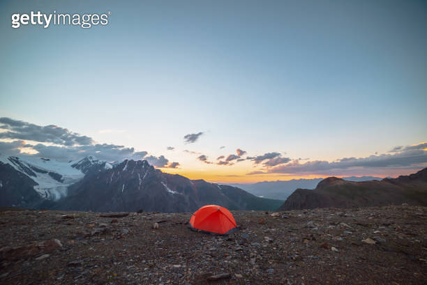 Scenic alpine landscape with tent at very high altitude with view to ...