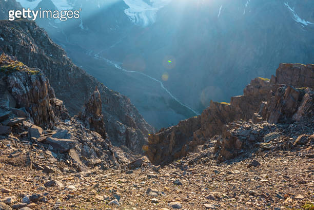Sunny mountain view from cliff at very high altitude. Scenic alpine ...