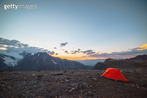 Scenic alpine landscape with tent at very high altitude with view to ...