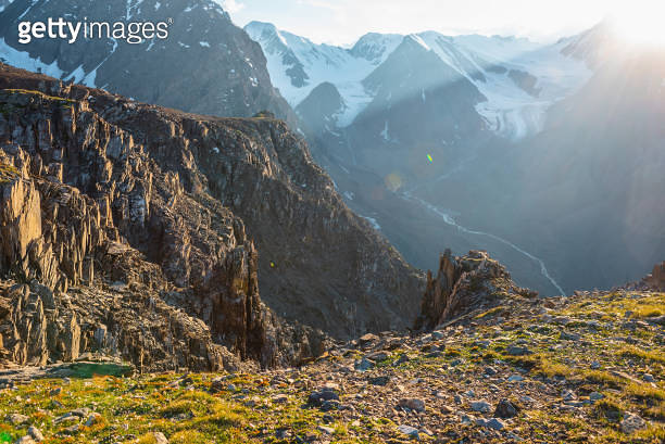 Sunny mountain view from cliff at very high altitude. Scenic alpine ...