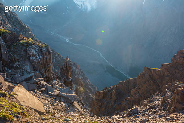 Sunny mountain view from cliff at very high altitude. Scenic alpine ...