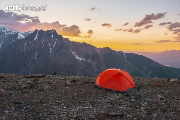 Scenic alpine landscape with tent at very high altitude with view to ...
