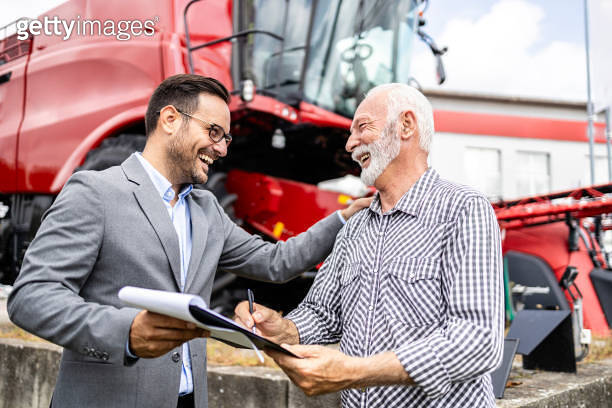 Farmer signing contract and buying new combine harvester for ...