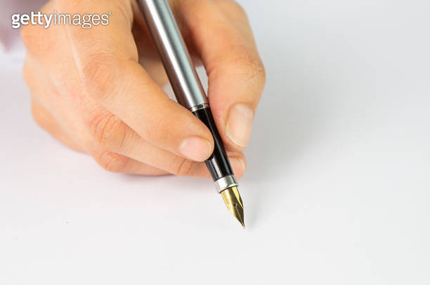 Cropped shot of an unrecognisable doctor writing notes in a folder in a ... Cropped shot of an unrecognisable doctor writing notes in a folder in a ...