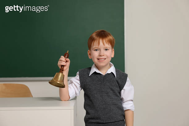 Cute little boy ringing school bell in classroom 이미지 (1490965327) - 게티이미지뱅크