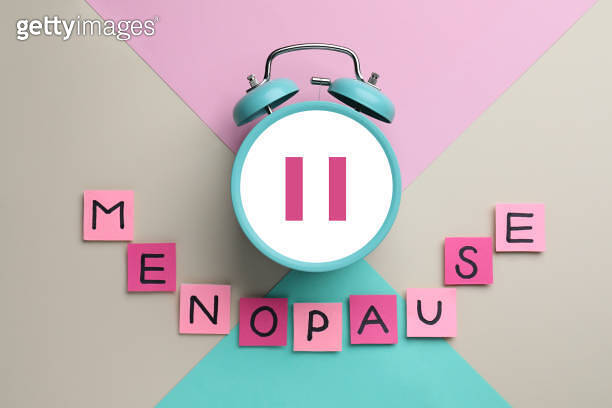 Menopause word of sticky notes with letters and alarm clock with pause ...