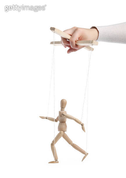 Woman pulling strings of puppet on white background, closeup ...