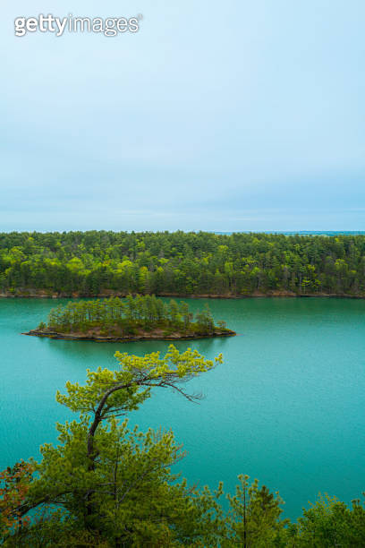 A small island with trees in Harpswell Cove over Cliff Trail, a hiking ...