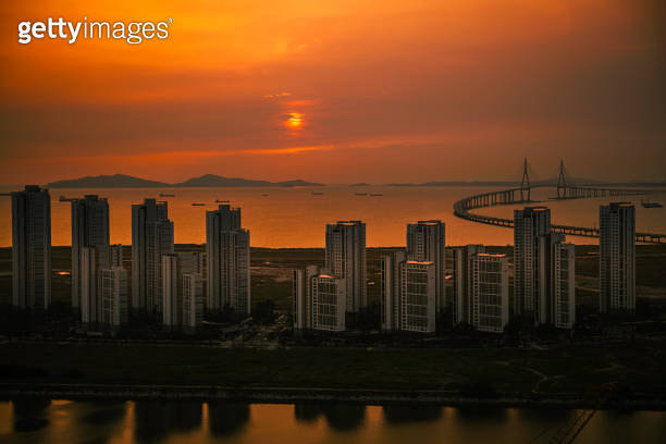 Incheon City Harbor skyline at overcasting sunrise with a view of the ...