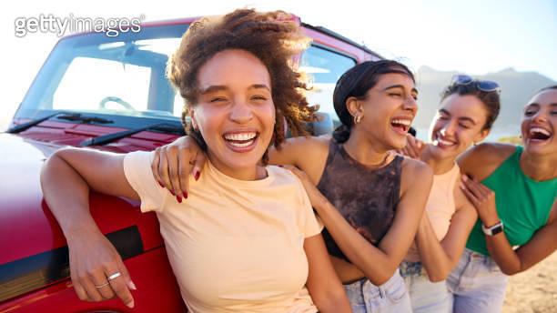 Portrait Of Laughing Female Friends On Vacation Having Fun Standing By ...
