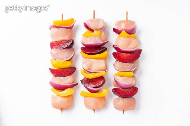 Uncooked mixed meat skewer with peppers.Skewers with pieces of raw meat ...
