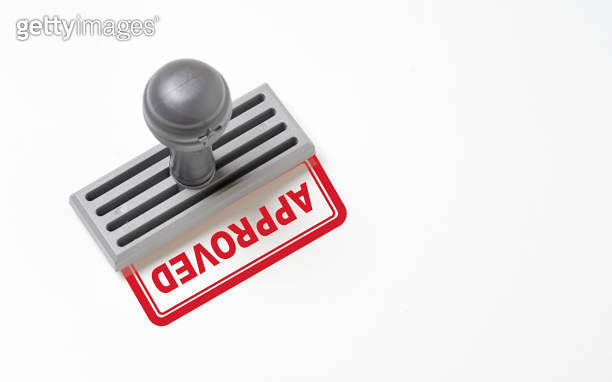 Isolate of Red text approved wording with rubber stamper on white ...