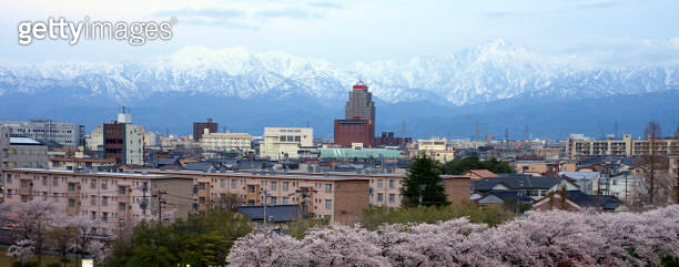 A view of Toyama City with the Tateyama Mountain Range as a beautiful ...