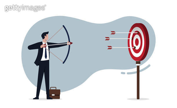 Businessman with bow and arrow try to hit the center bullseye in ...