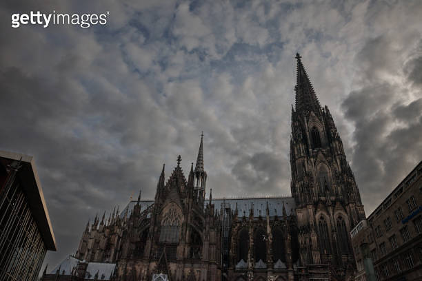 Cologne Cathedral seen from below with blue sky. Cologne Cathedral, or ...