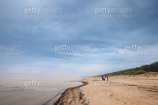 People facing the Fading Panorama of the Garciems beach (Garciema ...