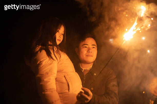 father and child setting off fireworks together 이미지 (1457874524) - 게티이미지뱅크