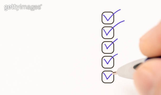 five checkboxes. hand with pen writing check mark on Checklist. Cropped ...
