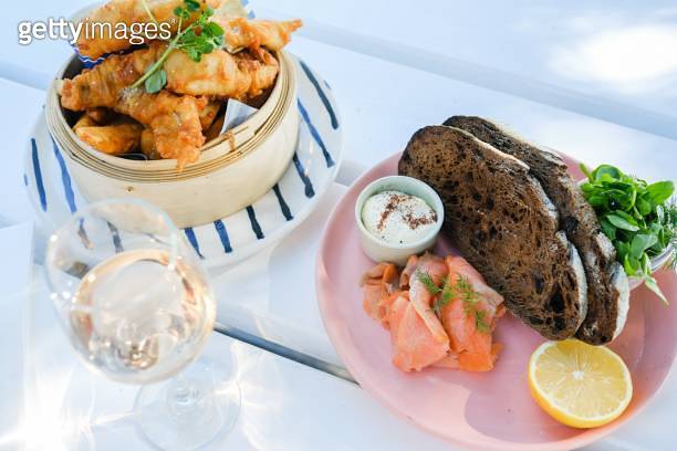Beer battered fish and smoked trout with dark rye at a café in Palm ...